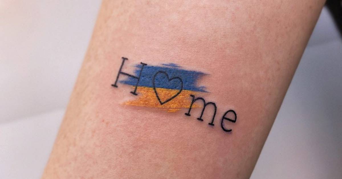 Tattoo of the word "home" and Ukraine's flag.