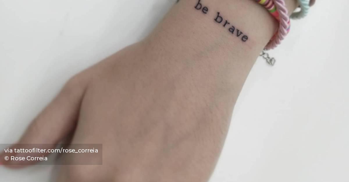 "Be brave" lettering tattoo located on the wrist.