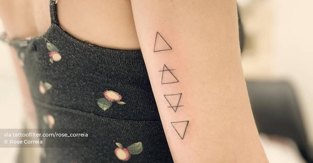 Alchemy symbols tattooed on the tricep, minimalistic