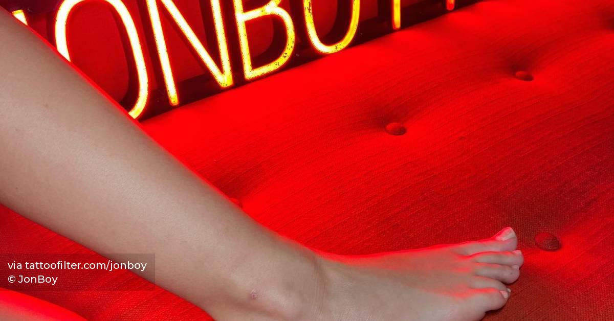 Tattoo of the word "sly" located on Emily Ratajkowski's