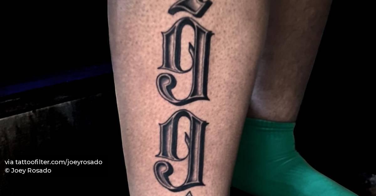 Large "1994" lettering tattoo located on the shin.