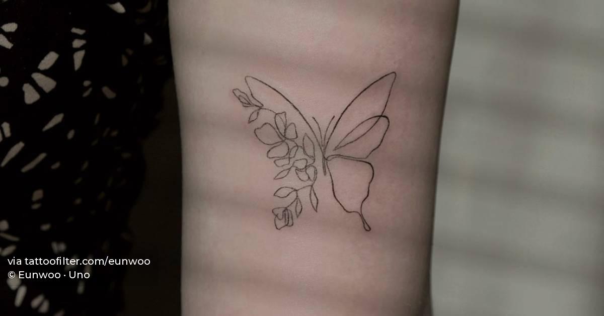 One line butterflower tattooed on the tricep.