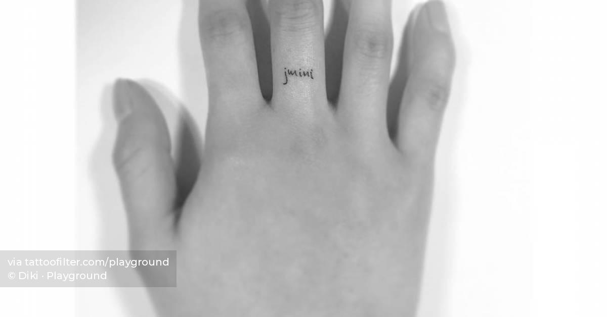 "Jmini" lettering tattoo located on the finger.