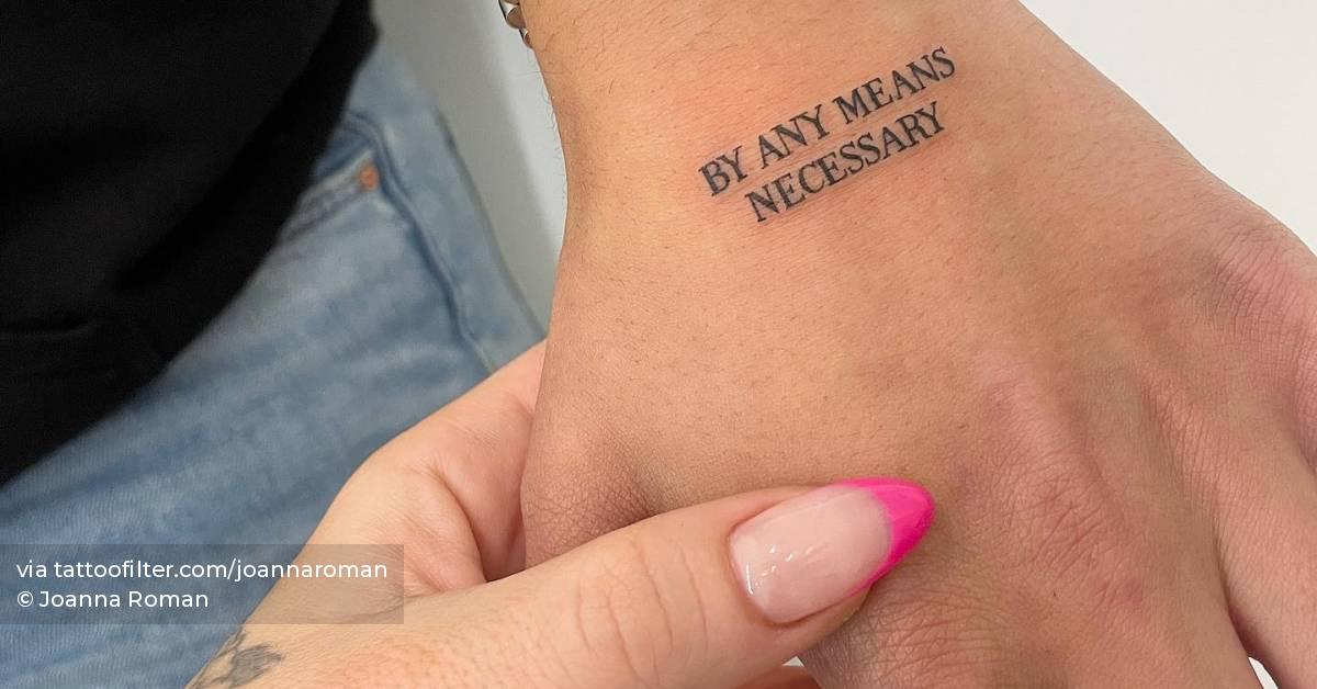 "By any means necessary" lettering tattoo located on