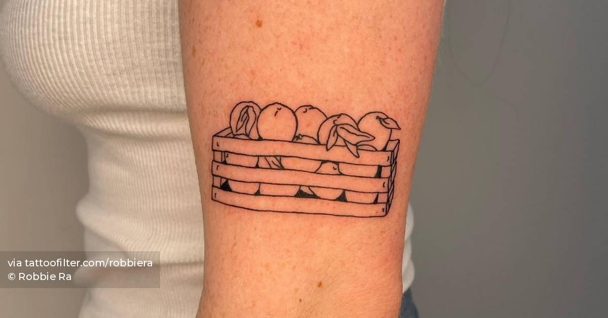 Orange box tattoo hand poked on the upper arm.