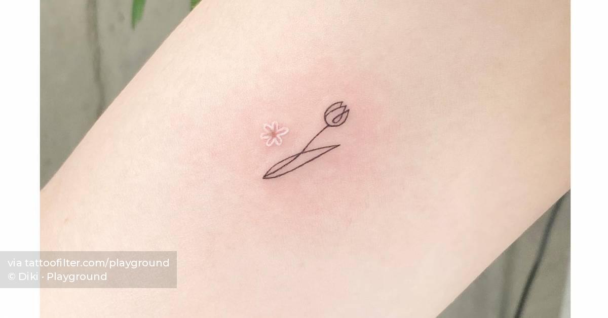 Fine line tulip tattoo done on the inner arm.