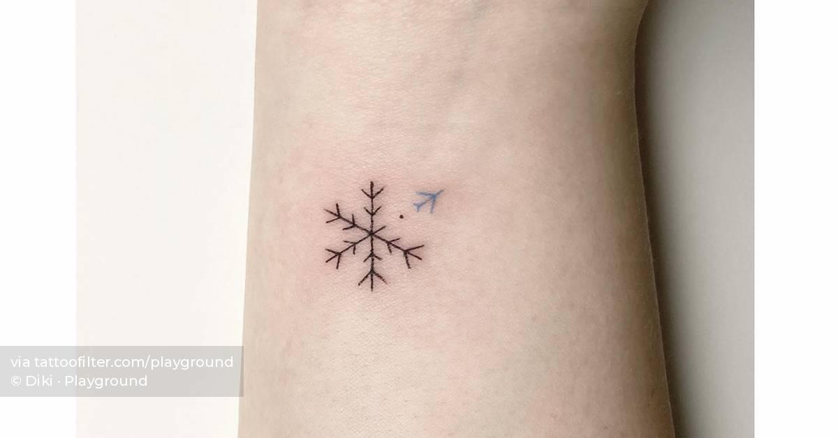 Fine line snowflake and airplane tattoo located on the