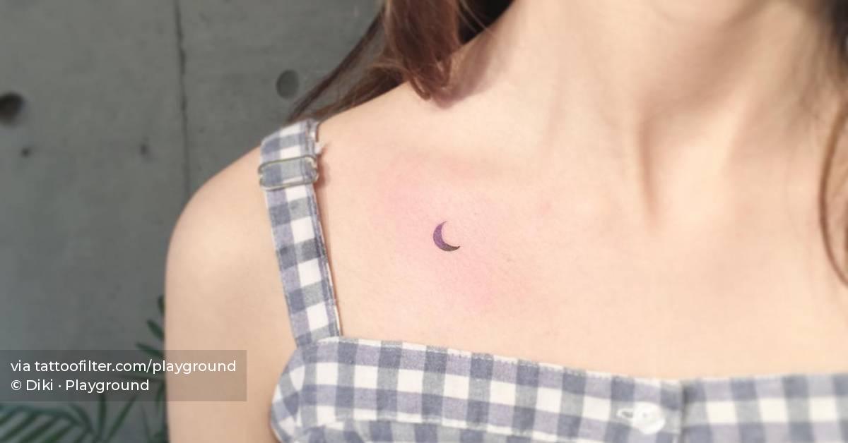 Crescent moon tattoo located on the collarbone,