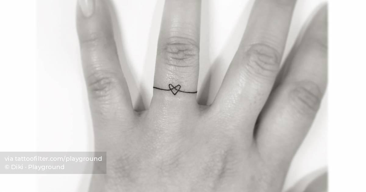 Minimalistic heart ring tattoo.