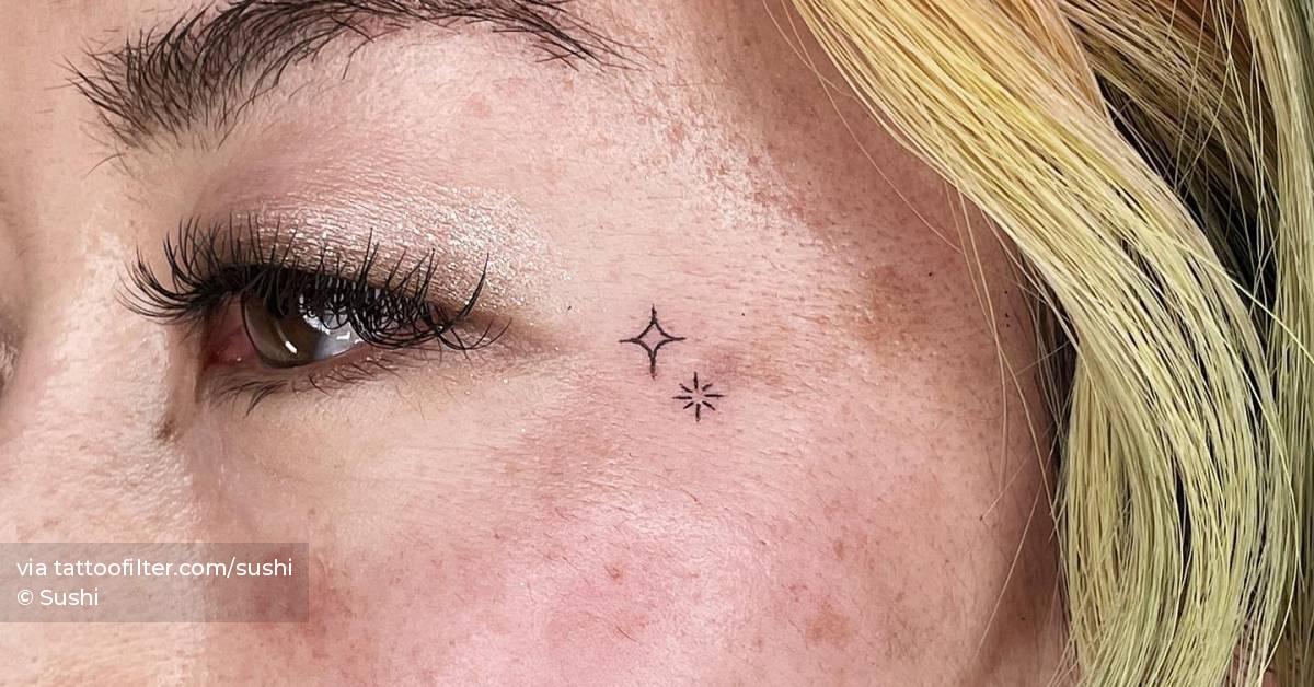 Tiny stars tattoo located on the face, minimalistic