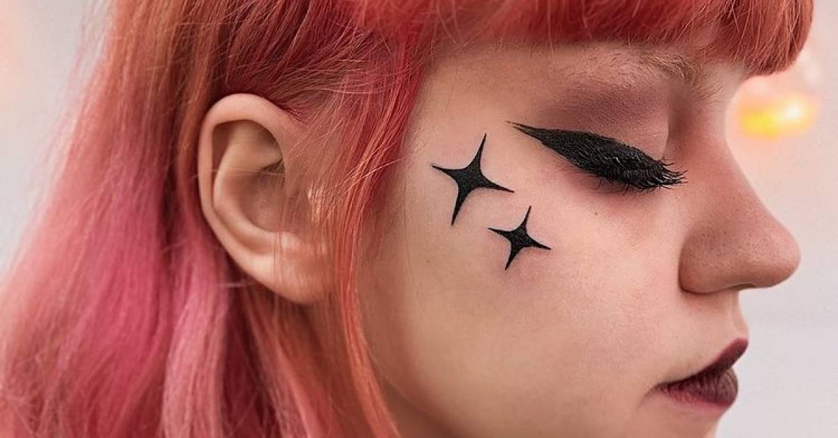 Minimalistic stars tattooed on the face.
