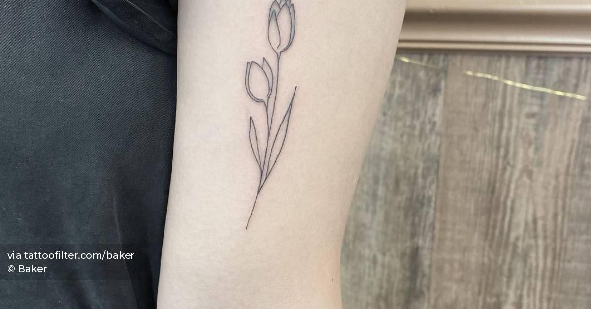 Fine line tulips tattooed on the bicep.