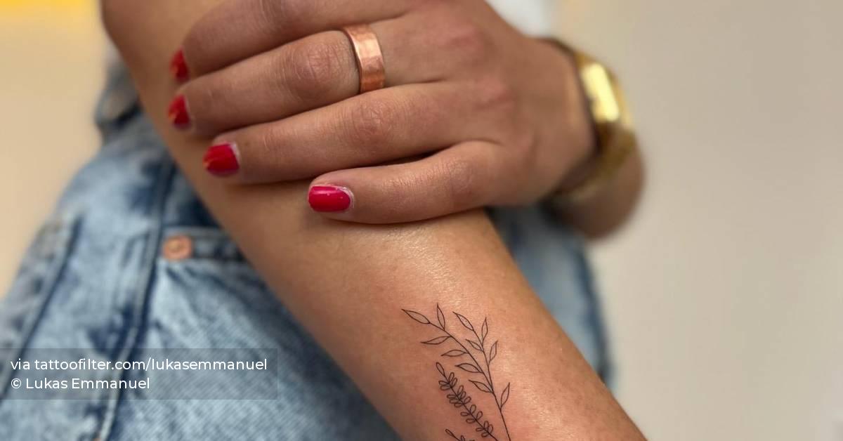 Fine line lavender tattoo located on the wrist.