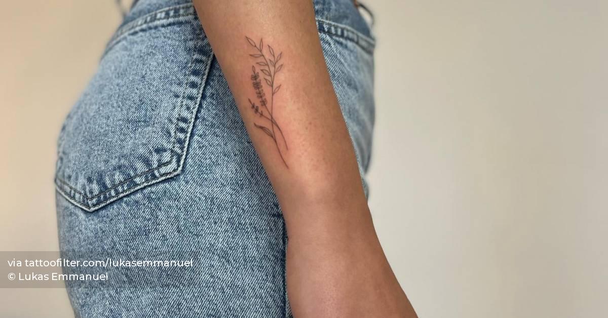 Fine line lavender tattoo located on the wrist.