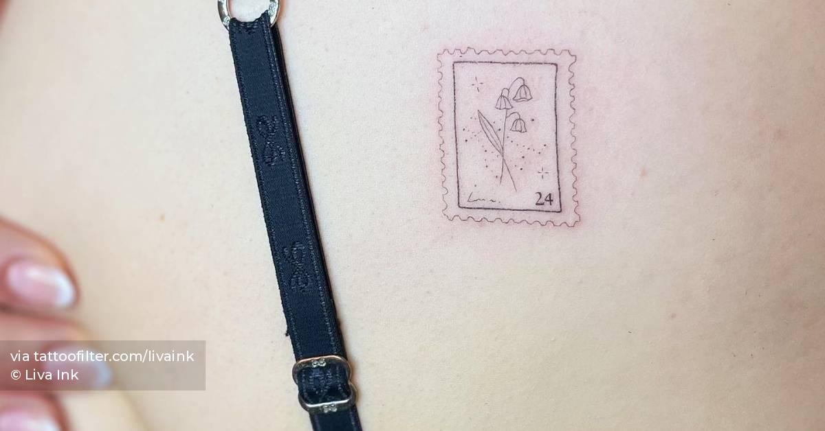 Fine line lily of the valley stamp tattoo located on