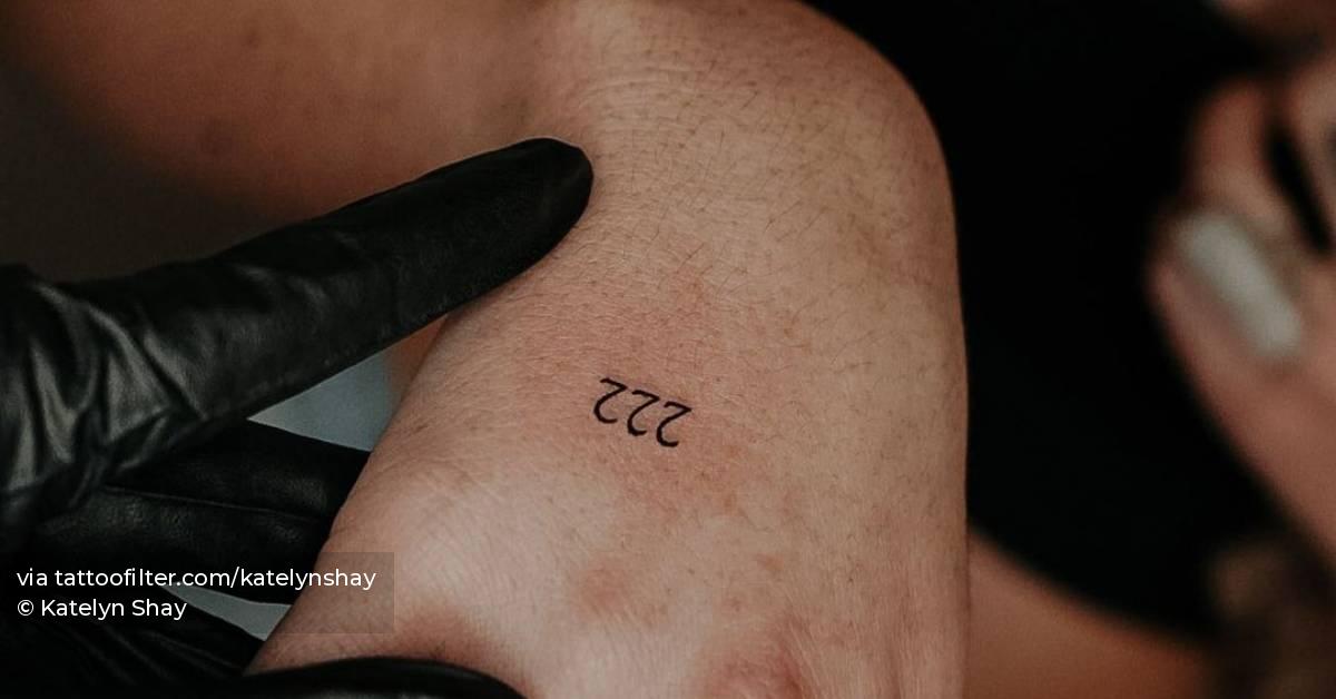 Number "222" tattoo located on the hand.