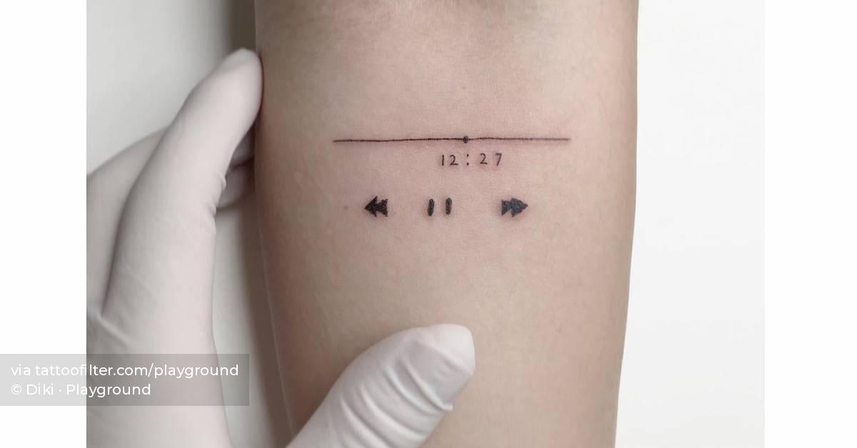 Media controls tattoo located on the inner forearm.