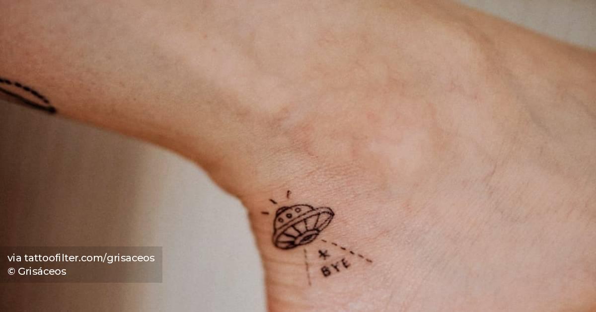 FIne line UFO tattoo on the ankle.