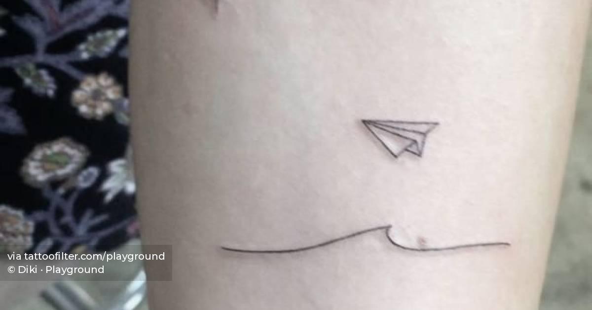 Fine line paper plane, wave and star tattoo located on