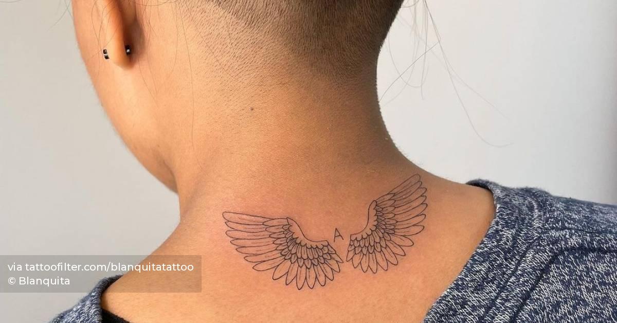 Fine line wings tattoo located on the upper back.