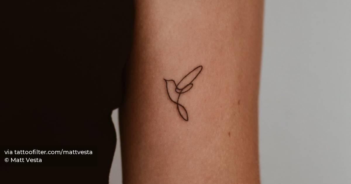 One line hummingbird tattoo located on the bicep.