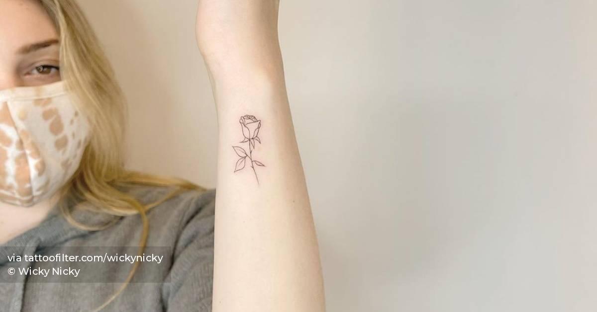 Fine line rose tattoo on the wrist