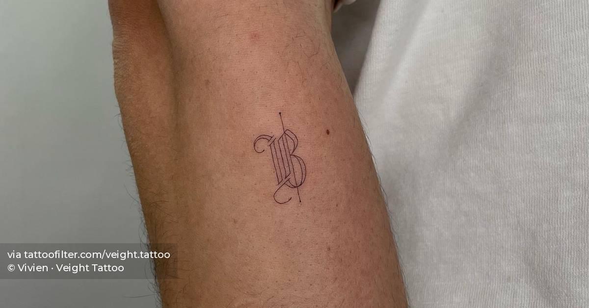 Tattoo of the letter "B" located on the forearm.
