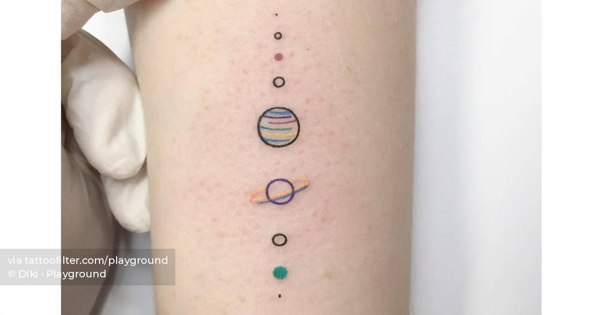 Minimalistic solar system tattoo located on the tricep.