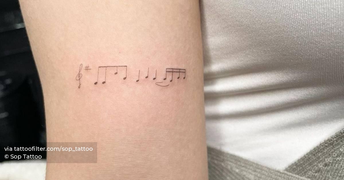 Music notes tattooed on the bicep.