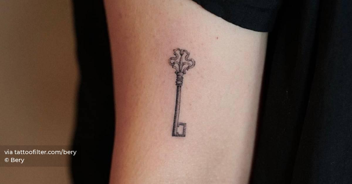 Micro-realistic key tattoo on the bicep.
