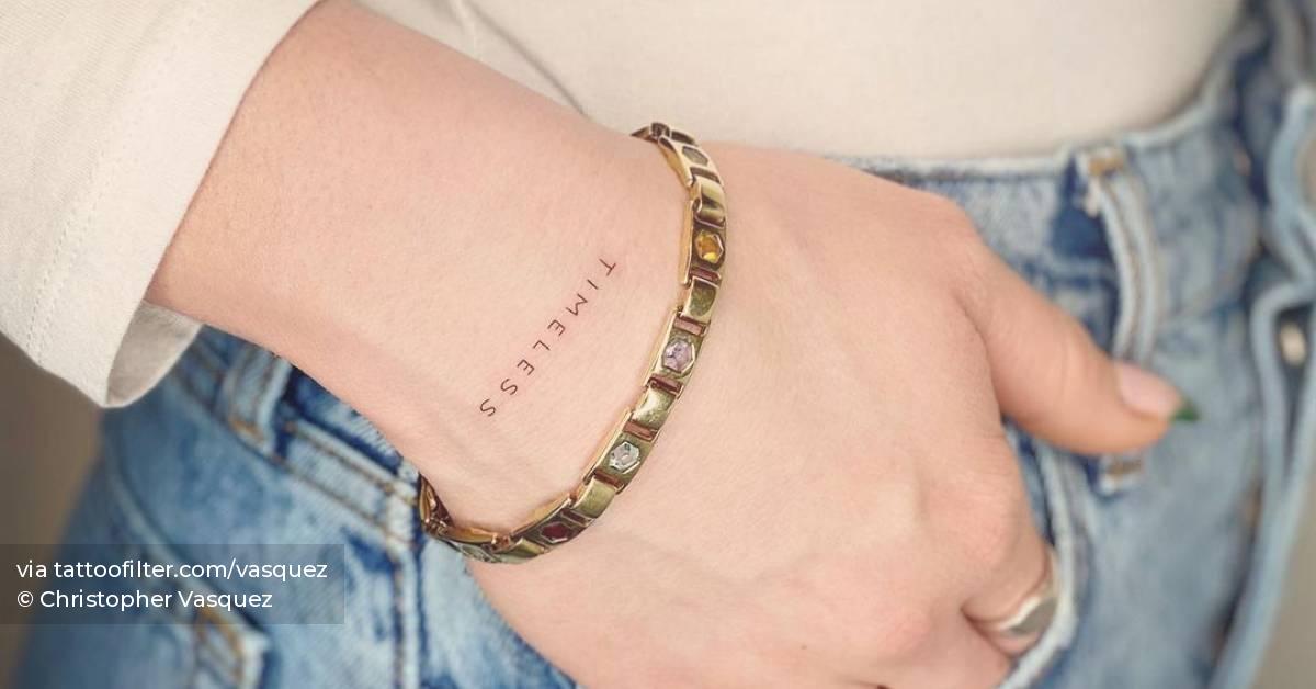 "Timeless" lettering tattoo on the wrist.