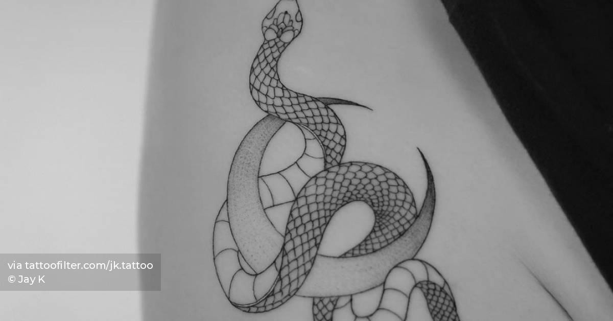 Fine line snake tattoo on the rib.