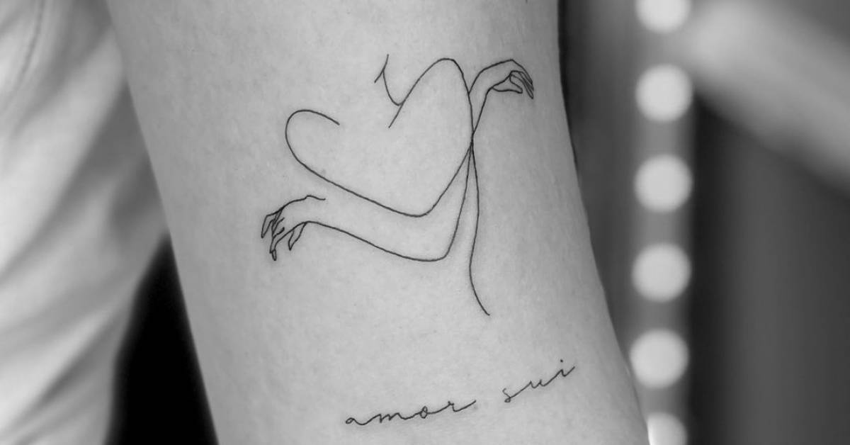 'Self Love Woman' tattoo located on the bicep.