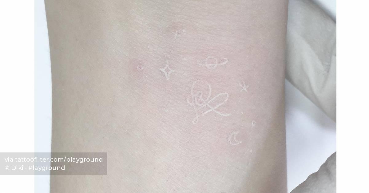 Minimalistic galaxy tattoo done in white ink, located