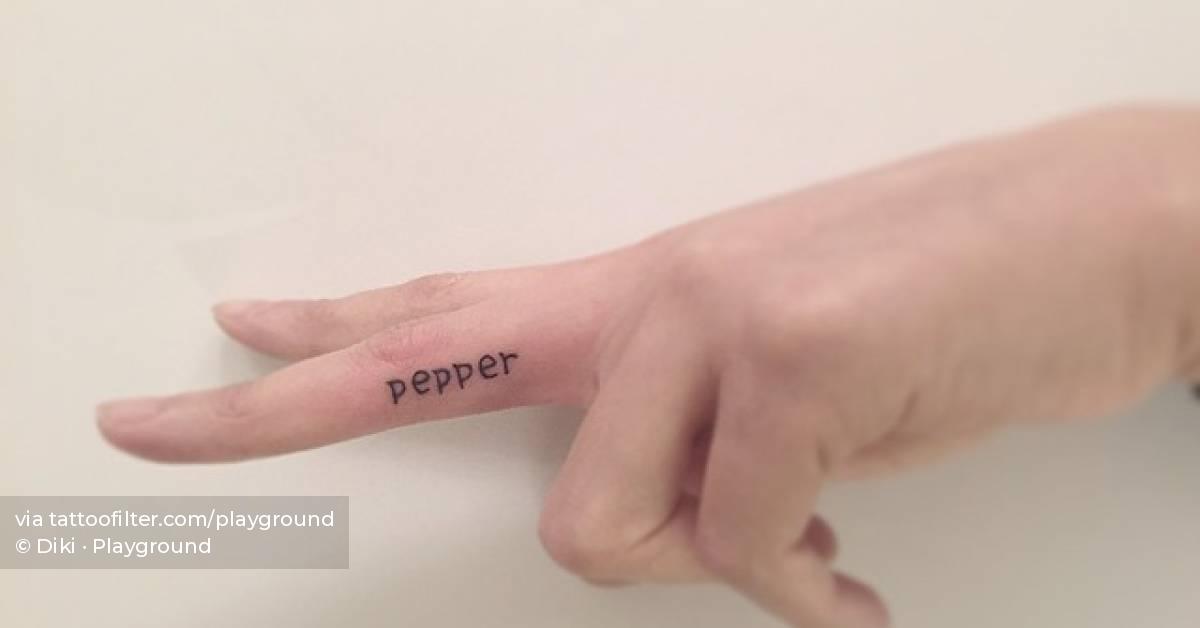 "Pepper" lettering tattoo located on the finger.