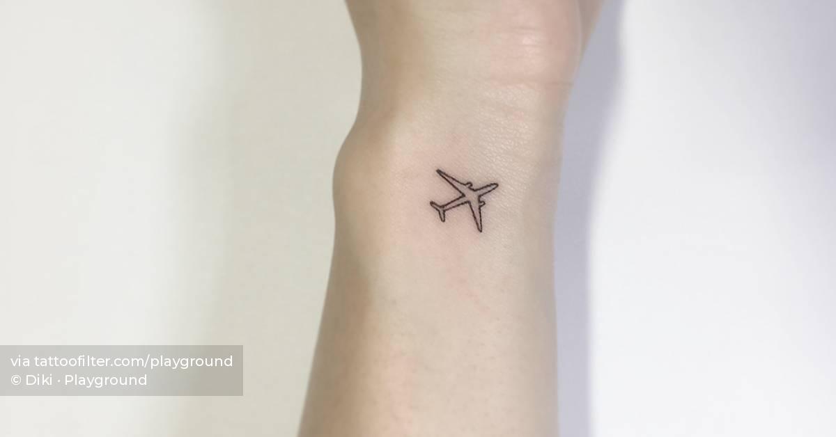 Tattoo of a an airplane in fine line located on the