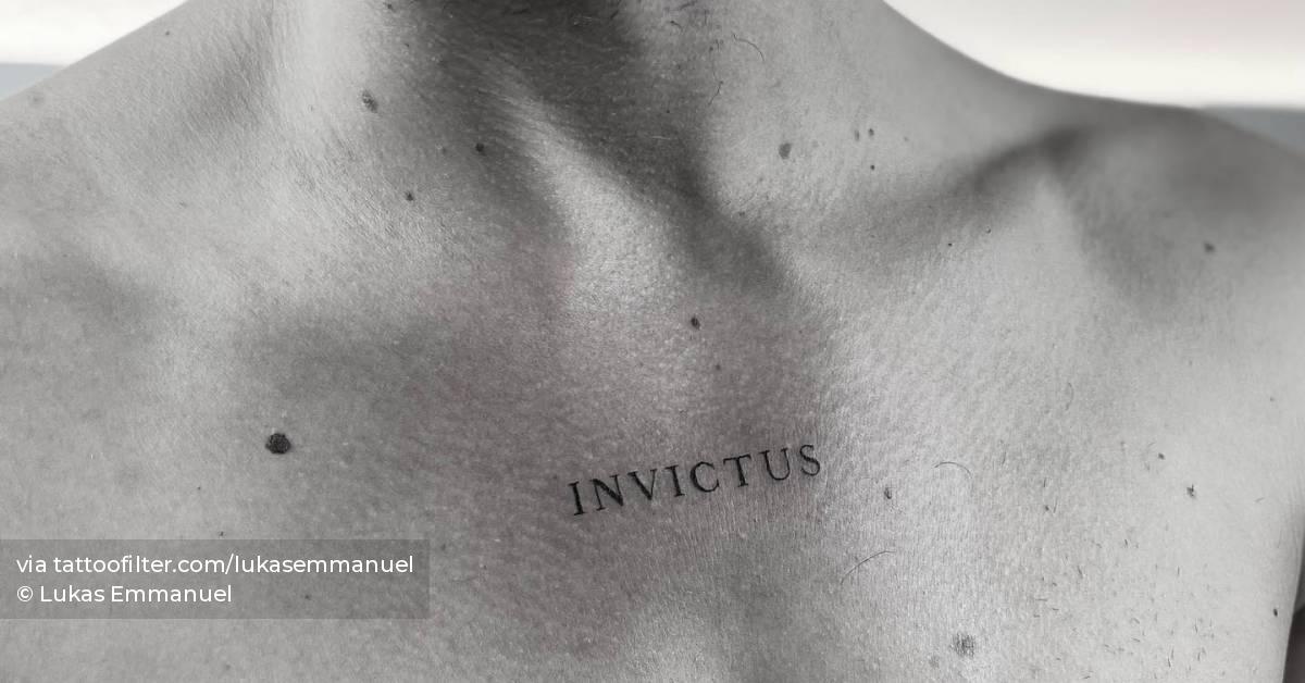 Tattoo of the word invictus located on the chest.