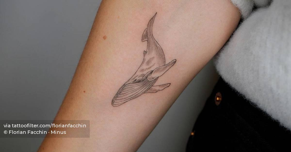 Fine line whale tattoo on the inner forearm.