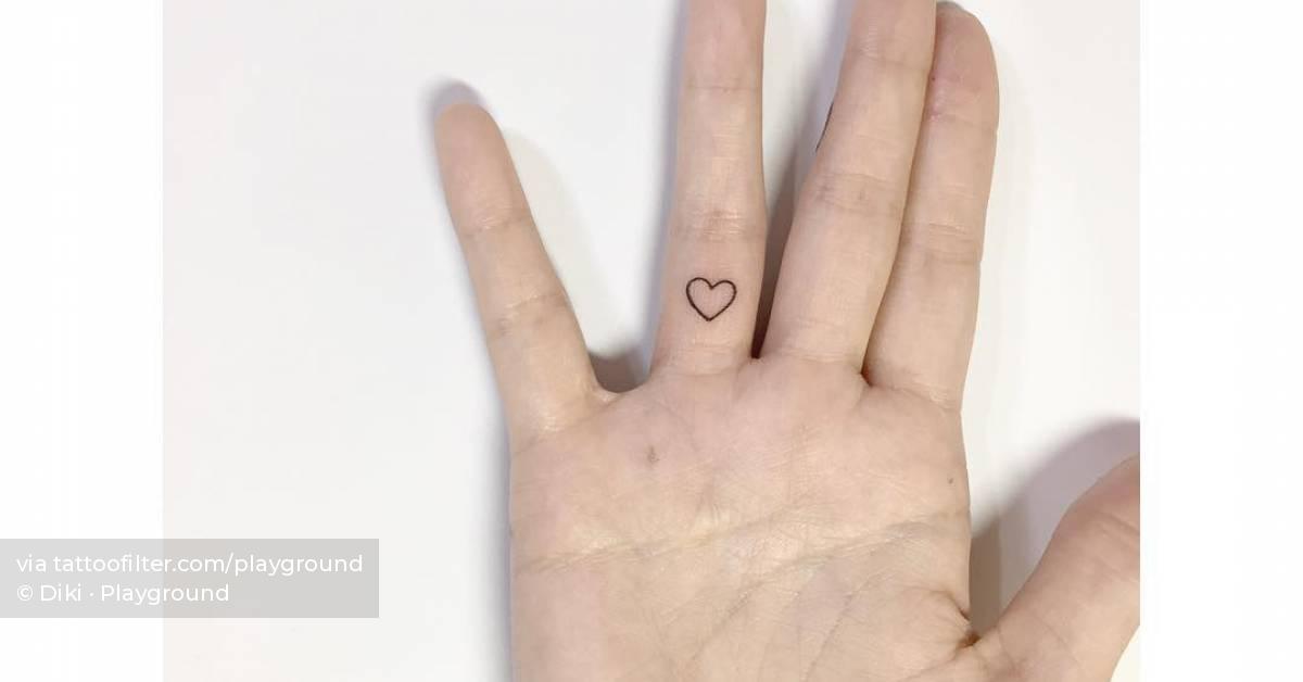 Tiny heart tattoo located on the finger, minimalistic