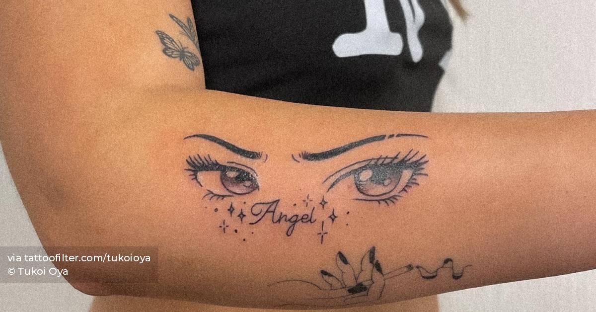 Eyes tattoo and the word "angel" located on the