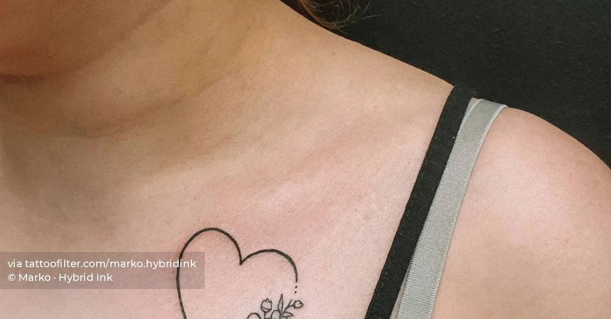 Floral heart tattoo located on the collarbone.