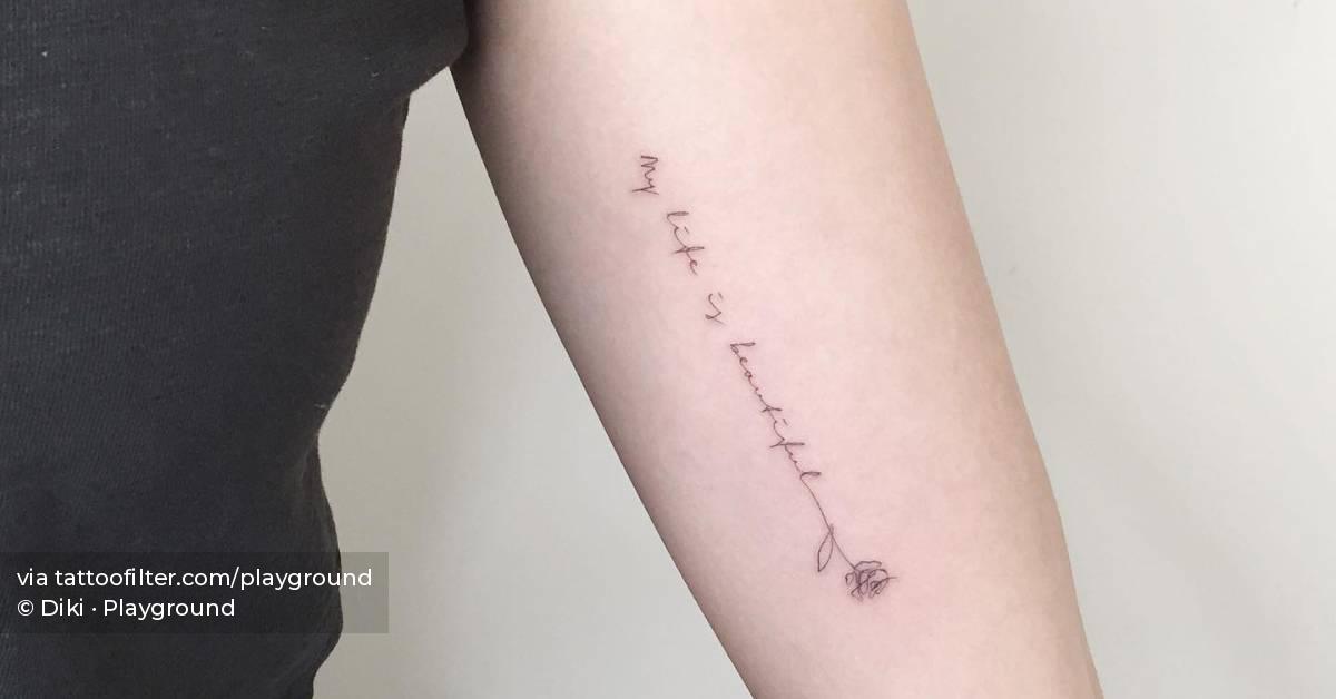 "My life is beautiful" lettering tattoo located on the