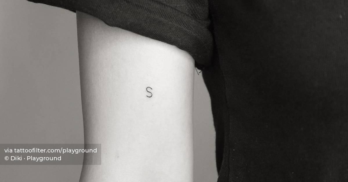 Tattoo of the letter "S" located on the inner arm.