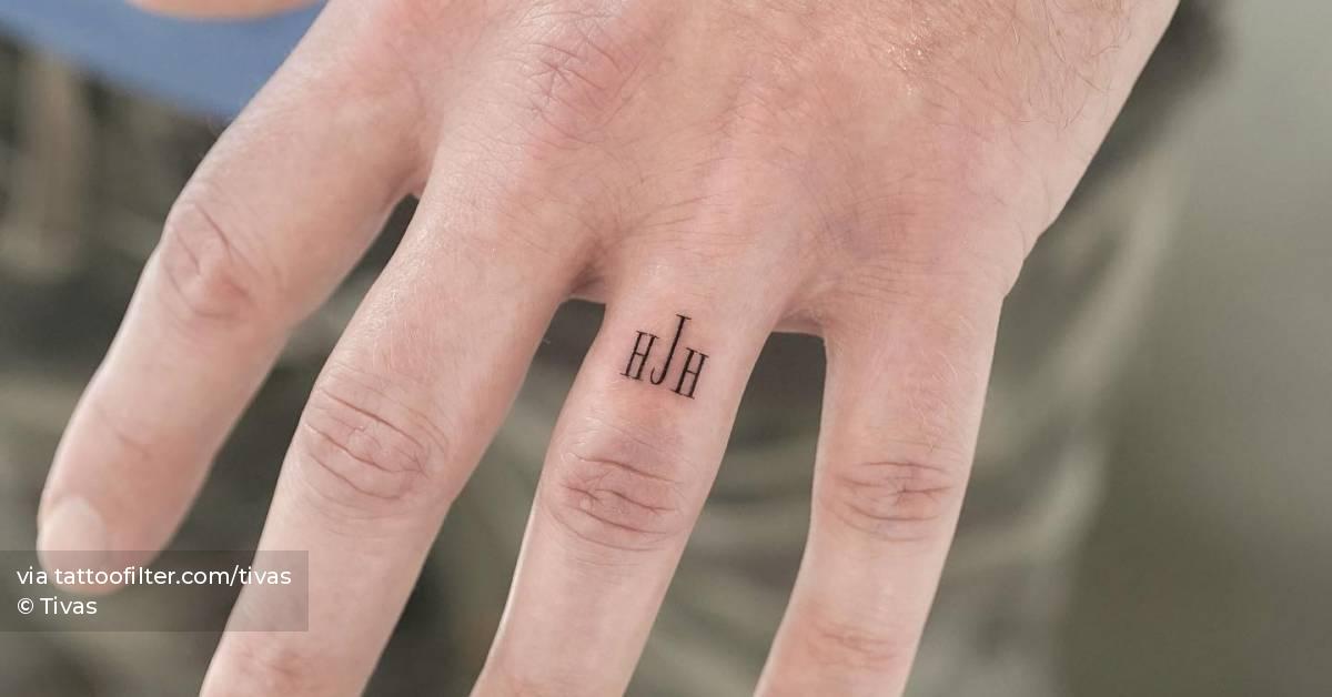 Minimalistic initials tattoo located on the finger.