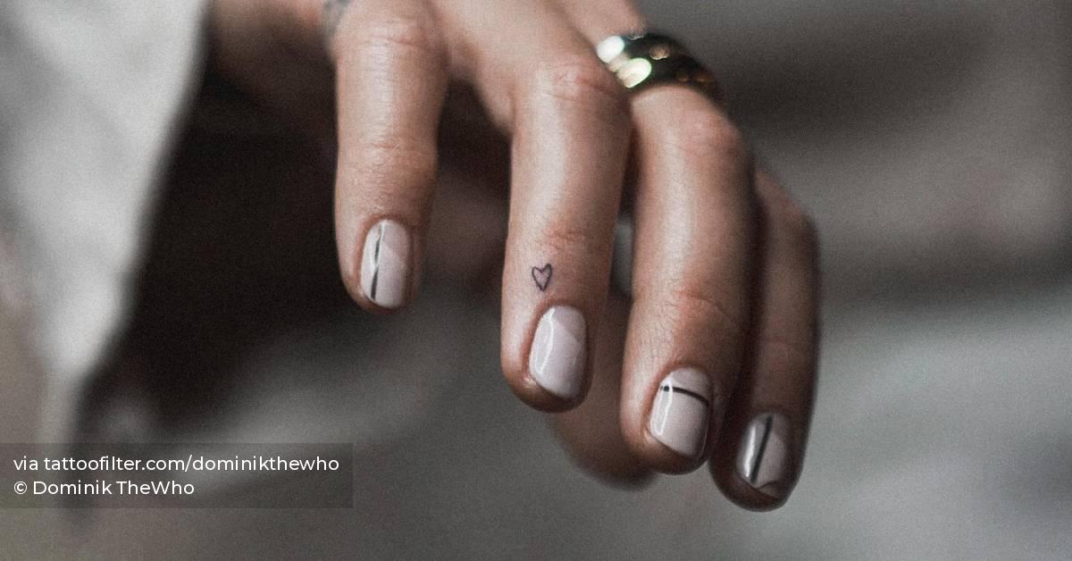 Micro heart tattoo located on the finger.
