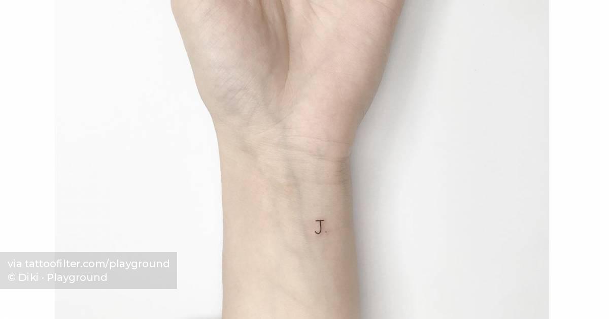 Tiny letter "J" tattoo located on the wrist.