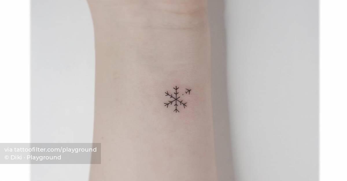 Fine line snowflake and airplane tattoo located on the
