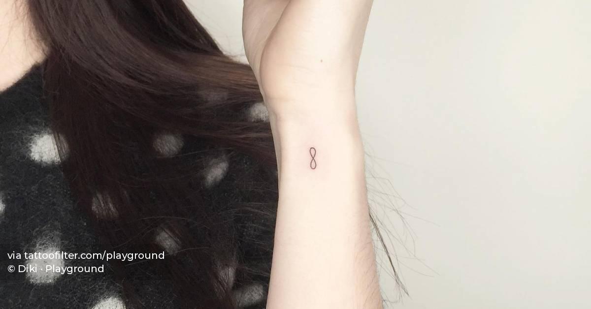 Tiny minimlistic infinity symbol tattoo located on the