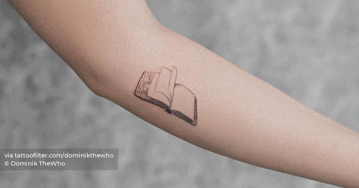 Book tattoo done on the inner forearm, illustrative