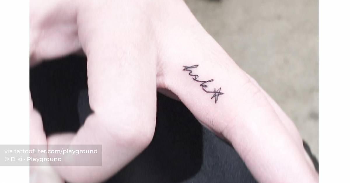 Handwritten initials tattooed on the finger.